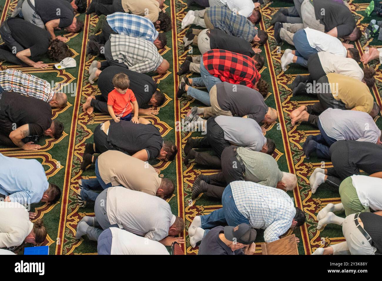 Dearborn, Michigan - A young boy sticks close to his dad during Friday ...