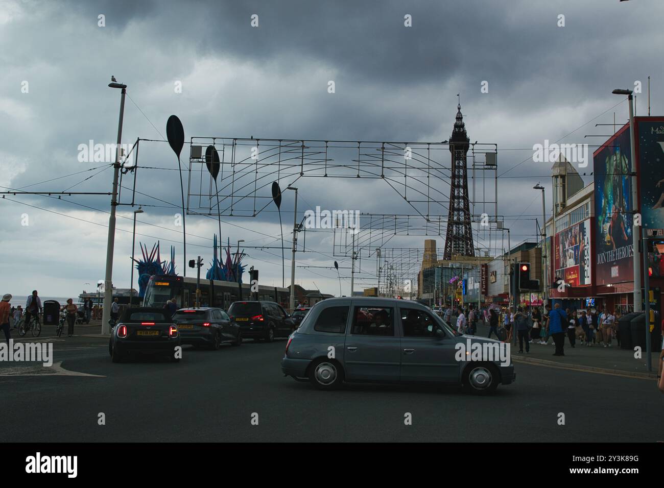 A busy street scene in Blackpool, England, featuring a grey taxi cab ...