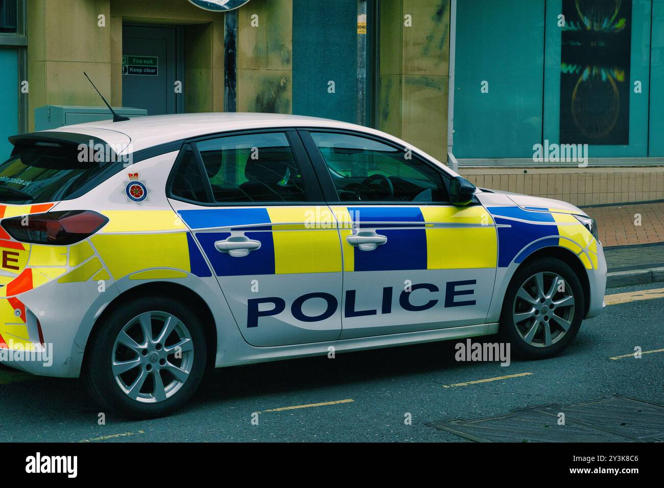 A police car parked on the street, featuring a distinctive blue and ...