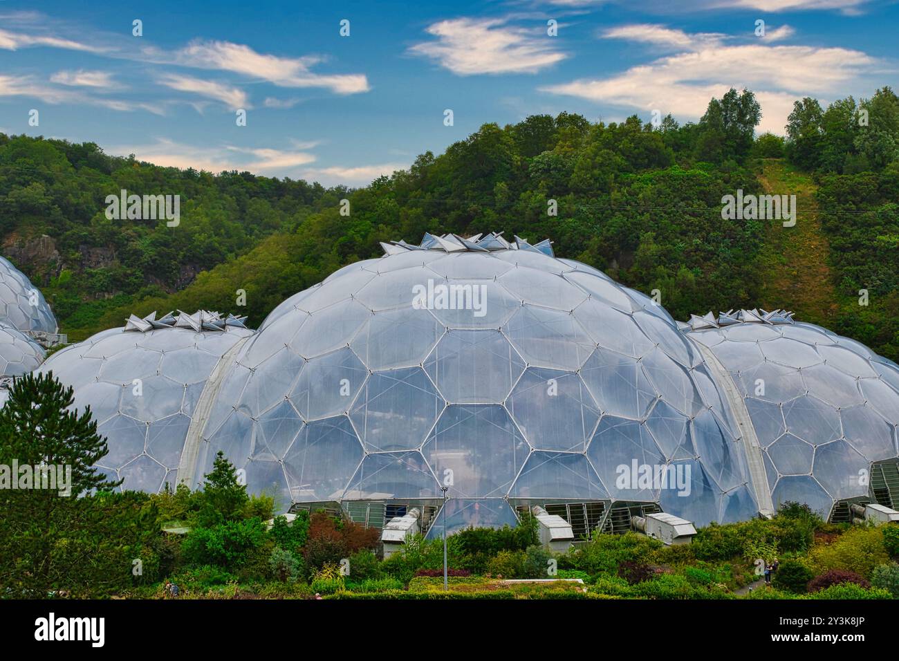 A view of large, geodesic domes made of glass and metal, surrounded by ...