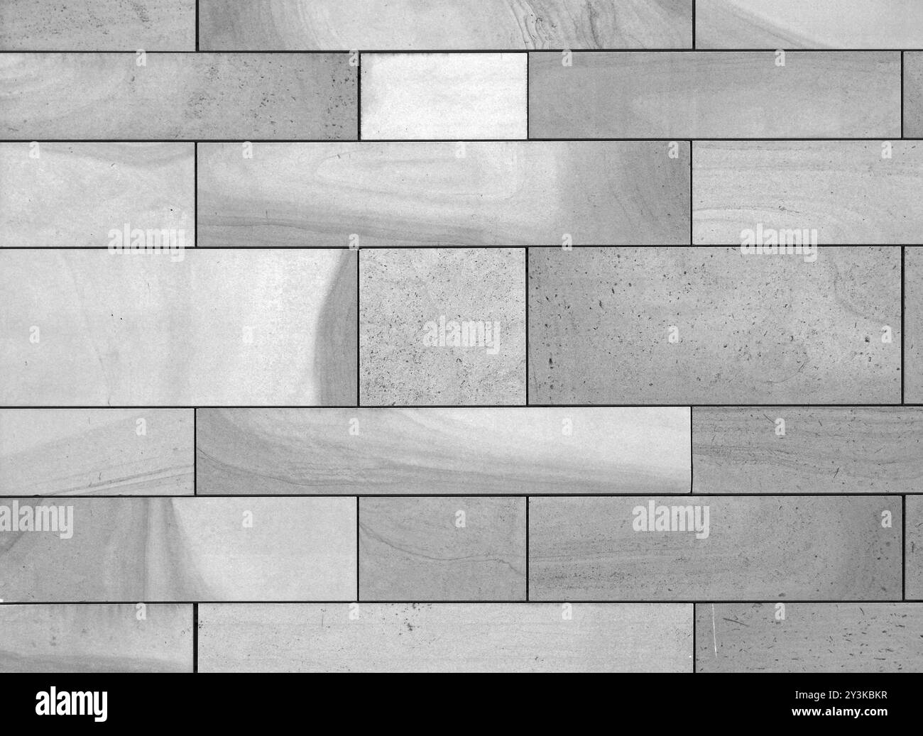Full frame image of a wall made of large flat blocks of textured grey ...