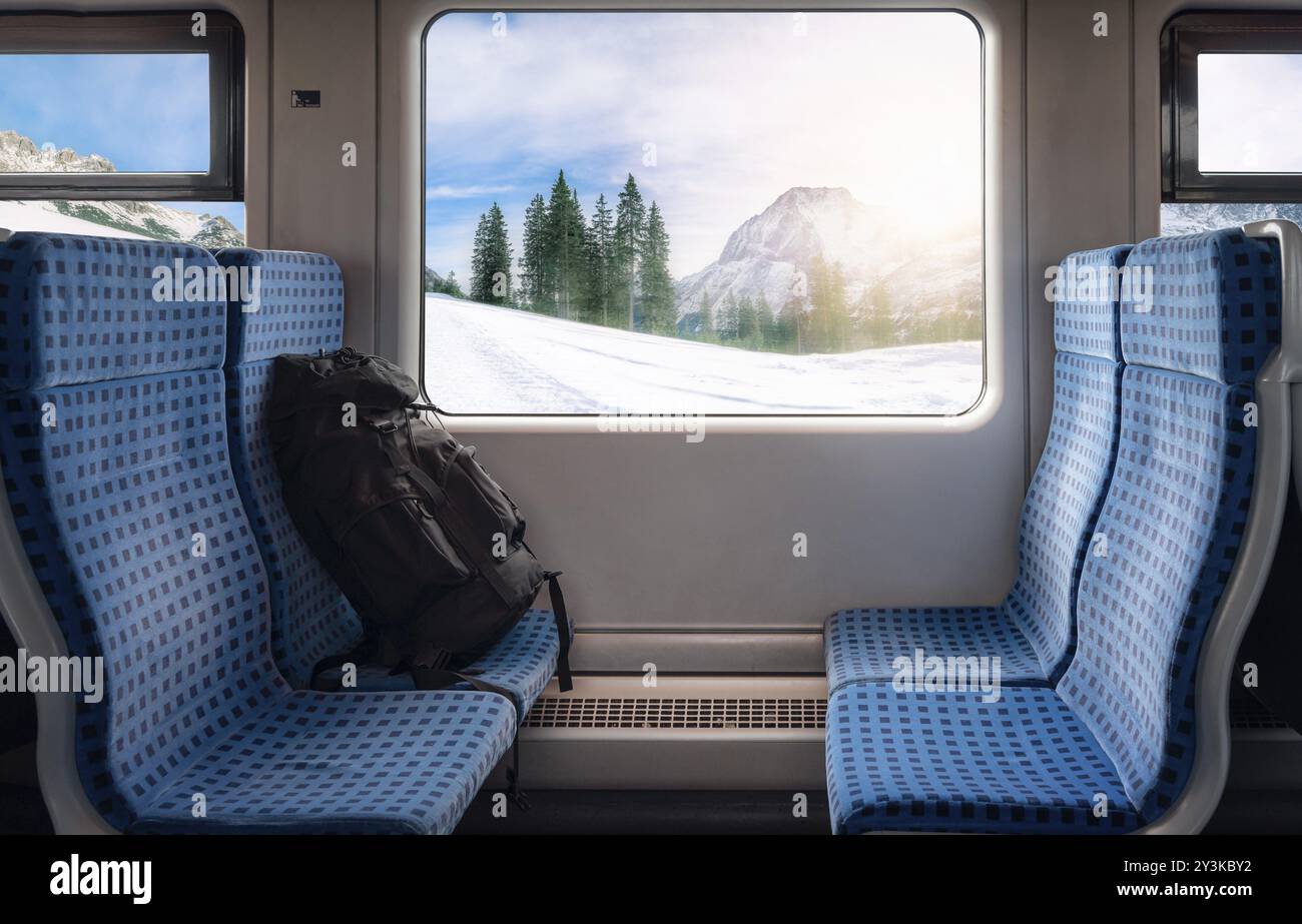 Winter travel concept image with blue train chairs, a backpack and an ...