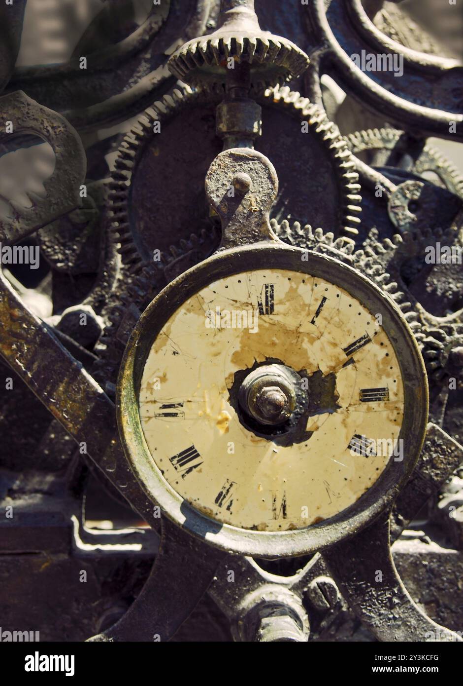 Ancient rusty iron clock with weathered face and exposed complex ...