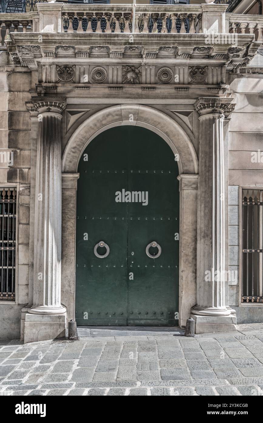Antique green door, arched, framed by two classic Doric columns and ...