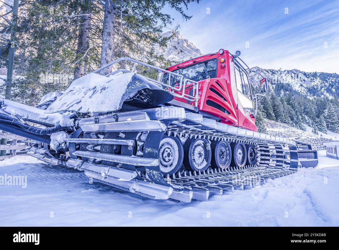 Side view of a snow groomer vehicle, showing details on its tracks ...