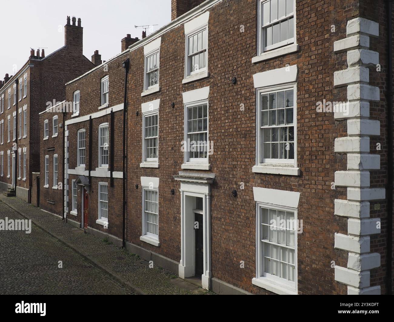 Street of old traditional red brick Georgian houses on a cobbled road ...