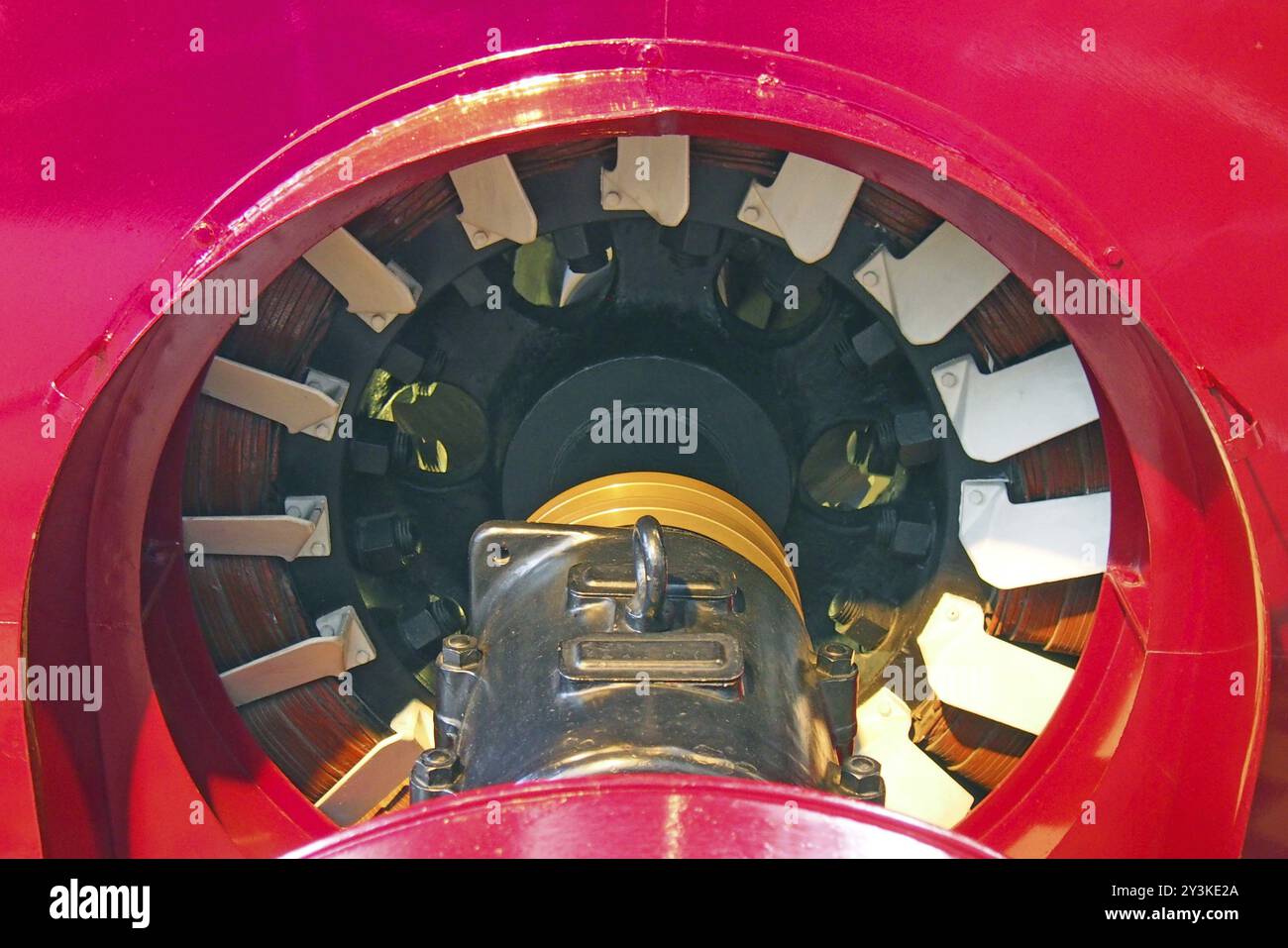 A close up of the drive shaft and coils of a large red industrial ...