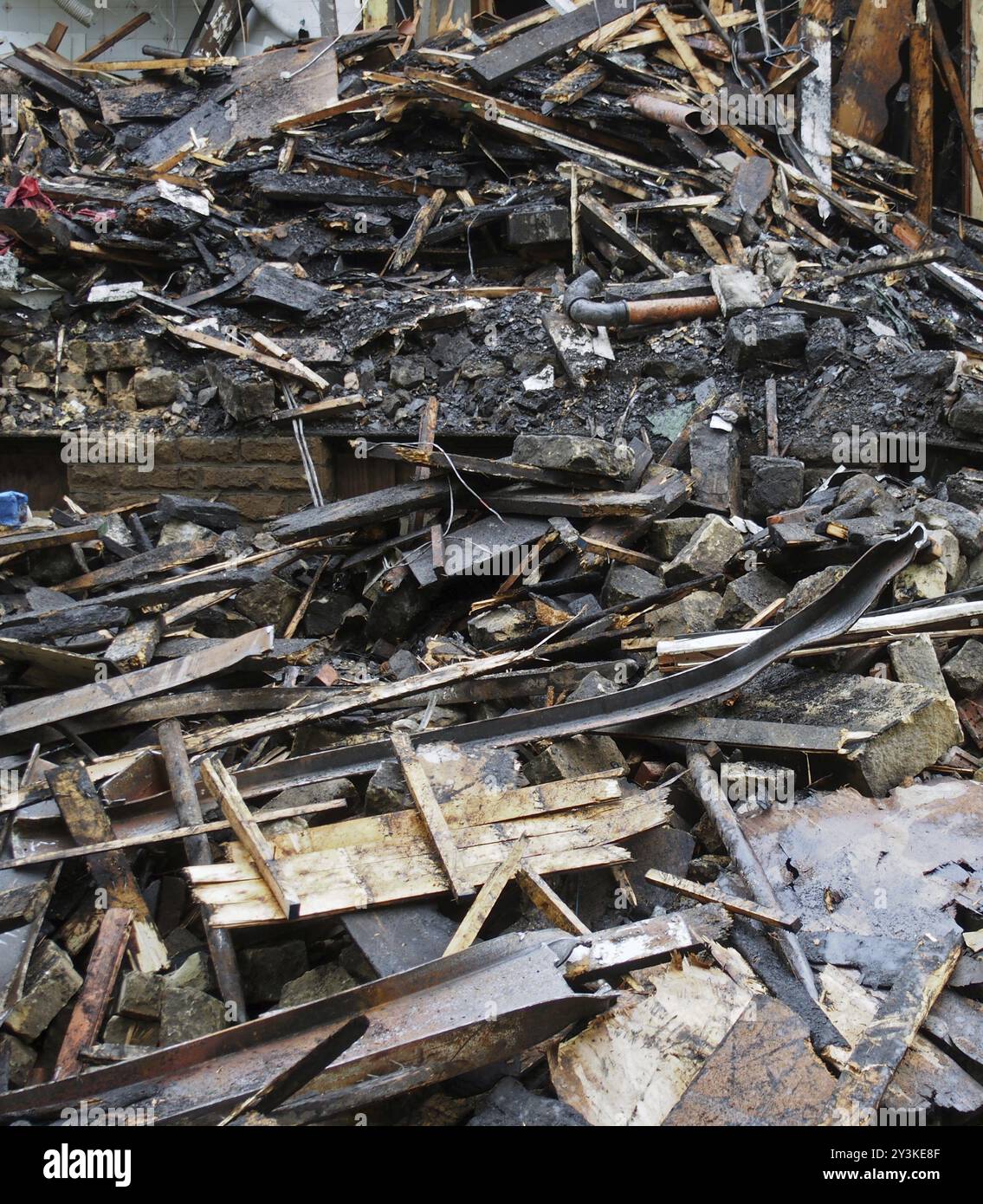 A heap of burned and scattered bricks beams and rubble after a fire in ...