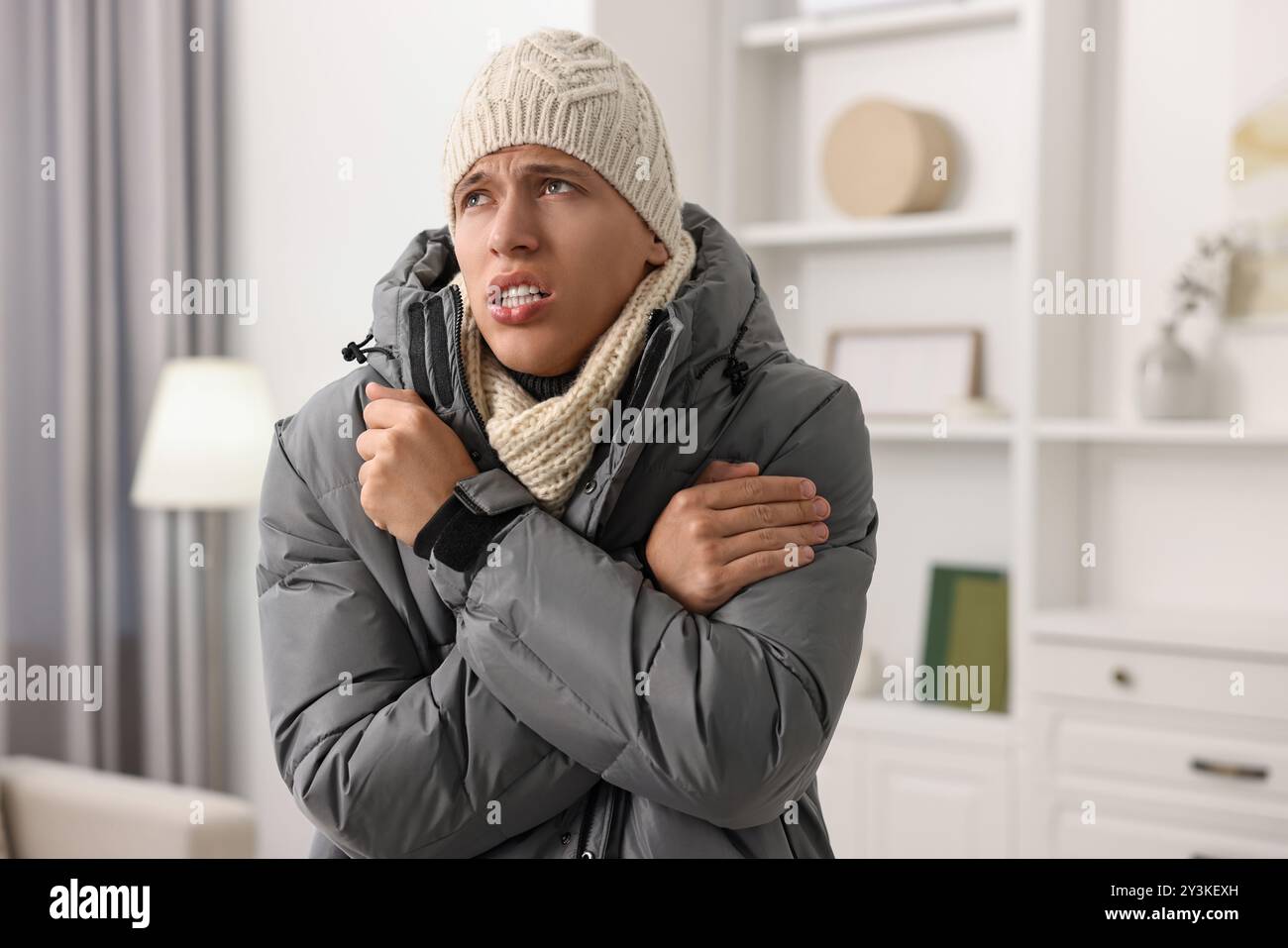 Cold symptom. Young man shivering from fever at home Stock Photo - Alamy