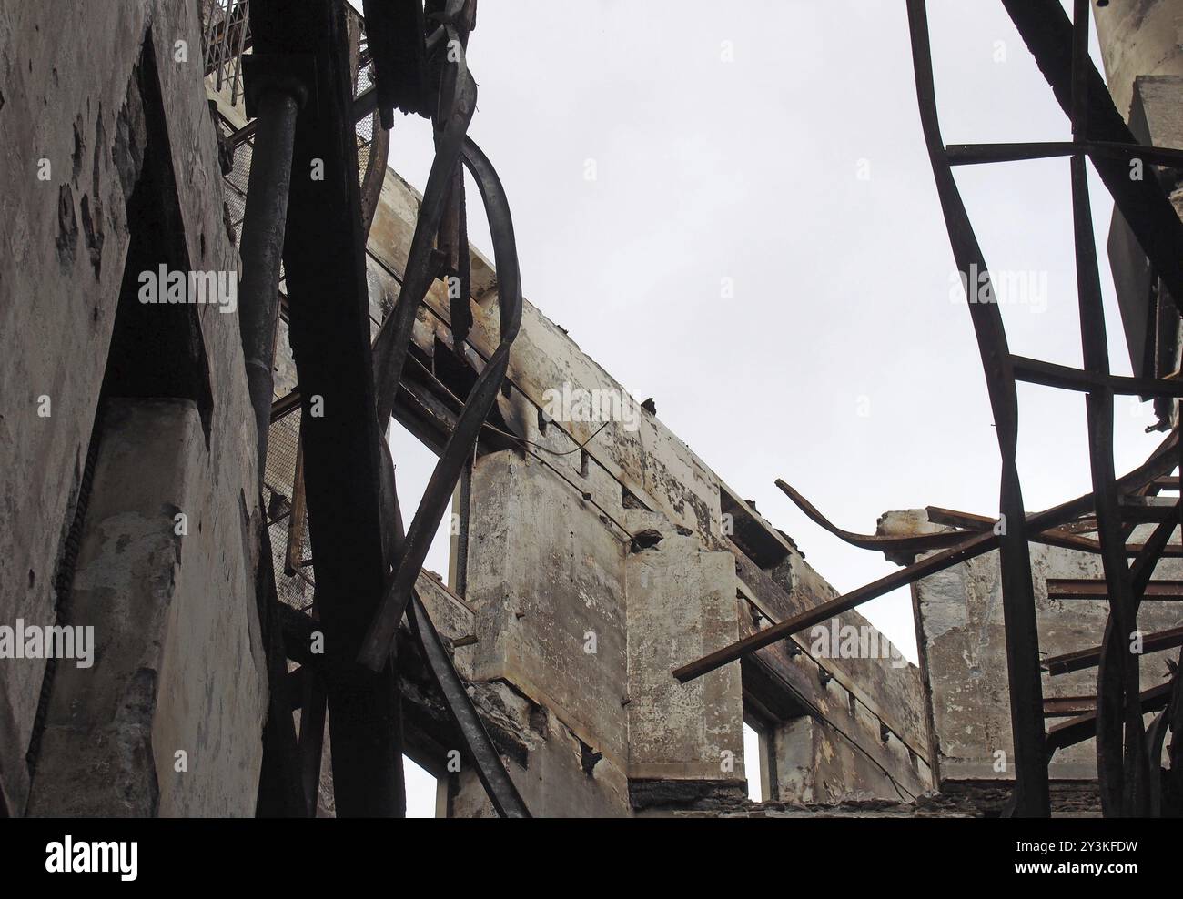 The interior of a destroyed industrial building with collapsing walls ...