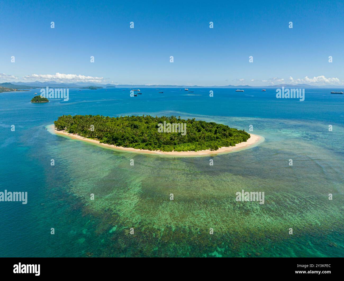 Air survey of Tropical island with a beach in the open ocean. Mindanao ...
