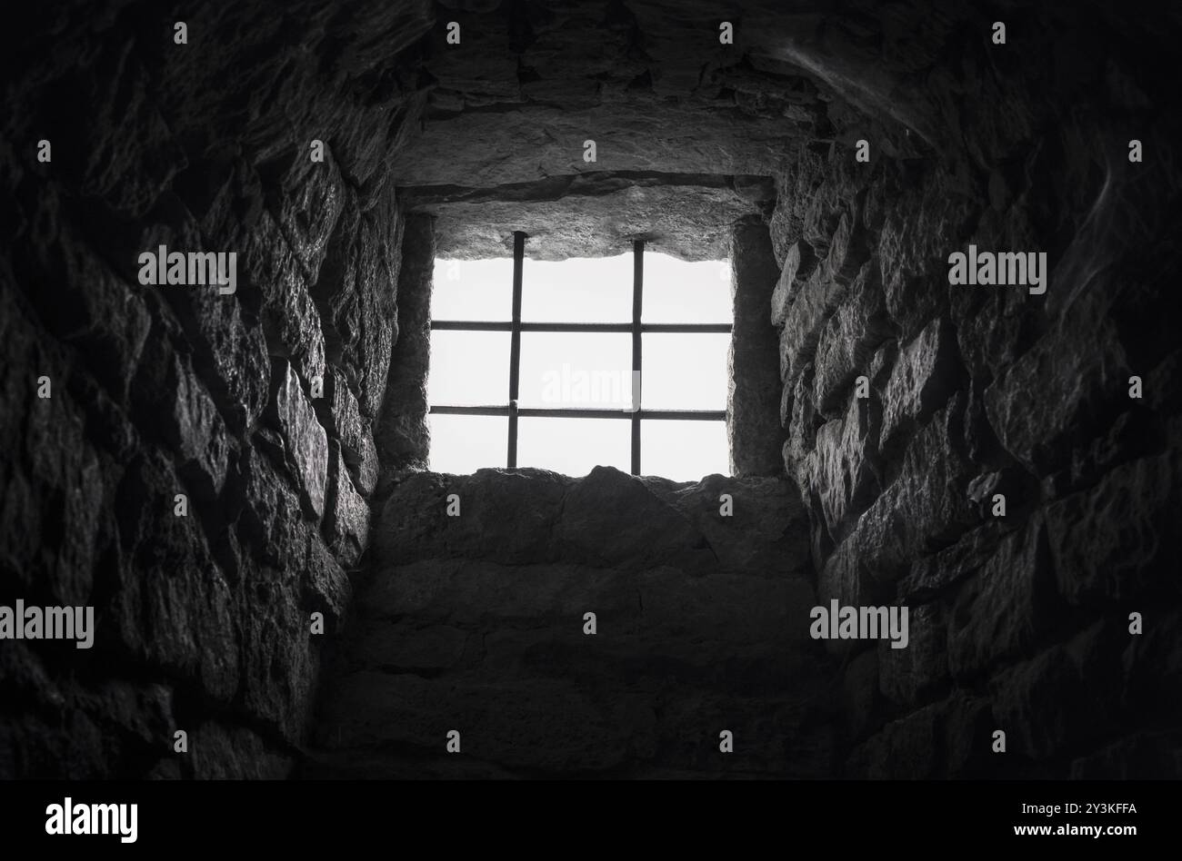 Interior image from an old basement built of stone with the barred ...