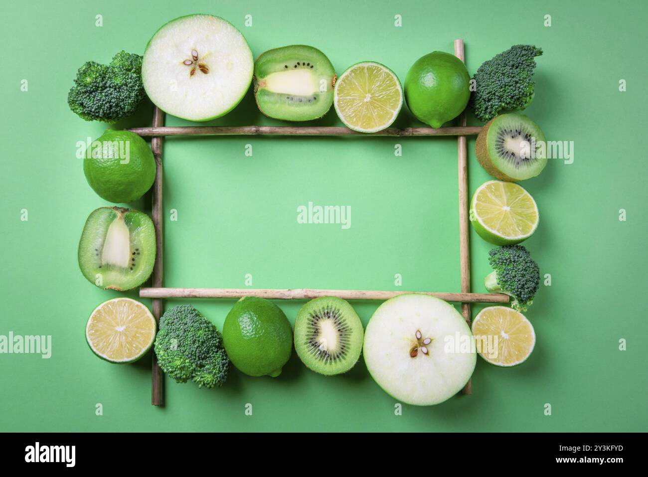 Sliced fresh fruits and vegetables displayed in a rectangular frame, on ...