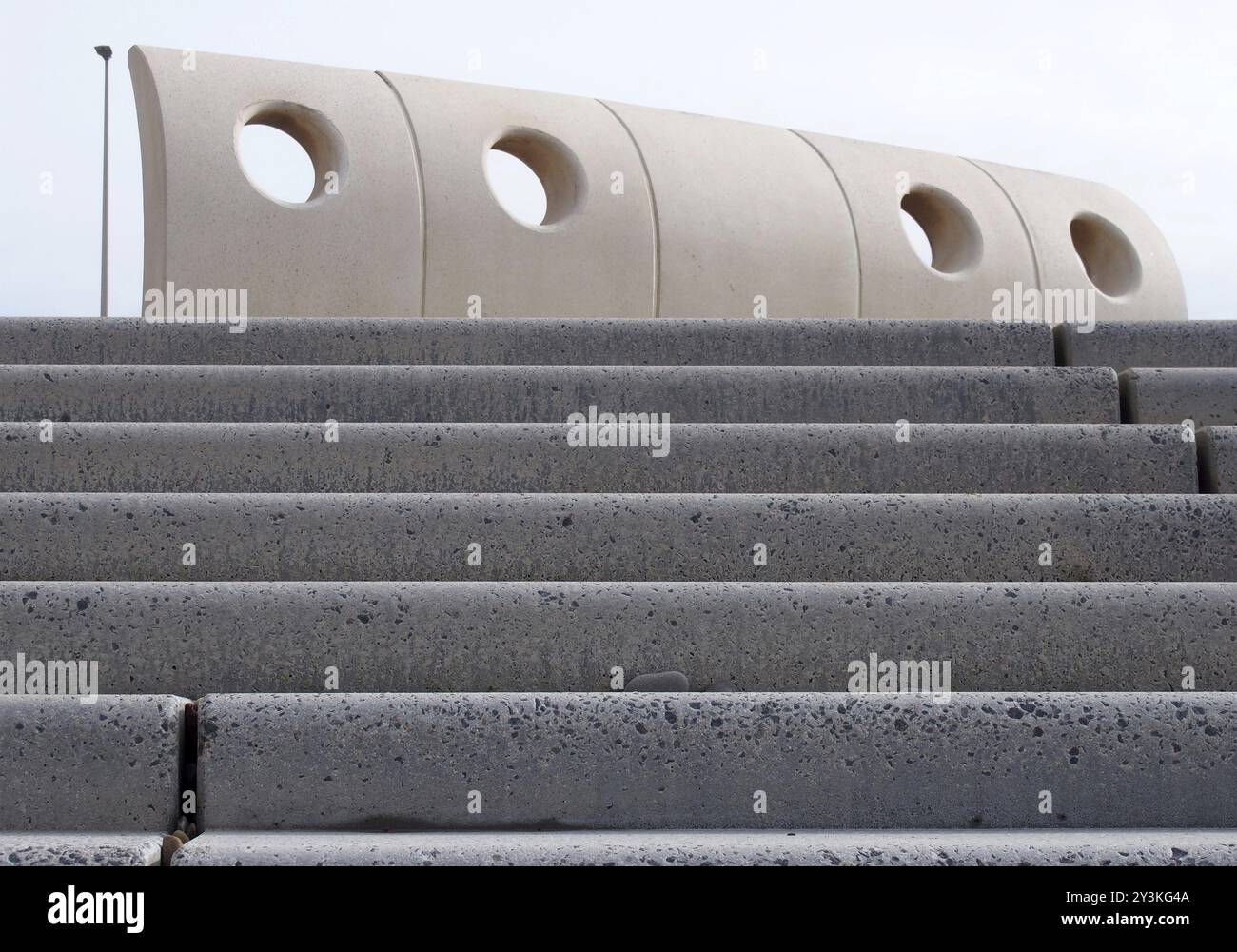 Grey textured outdoor concrete stairs with geometric curved wind ...