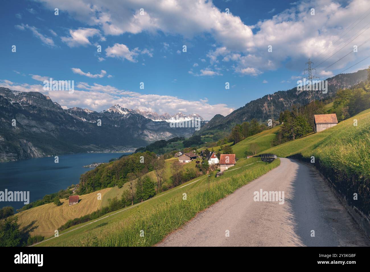 Spring landscape with country road toward a village, near Walensee lake ...
