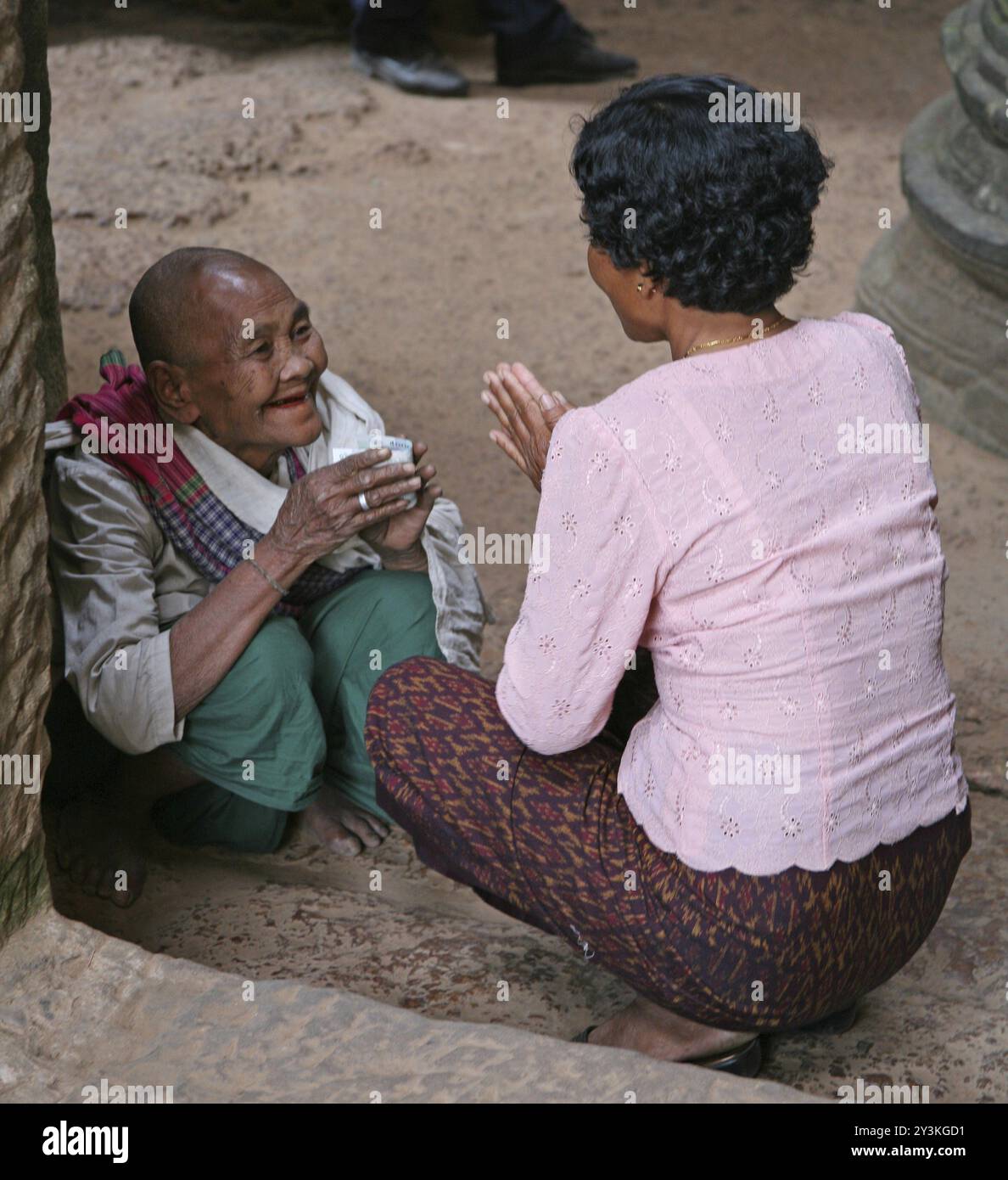 Lady is getting a blessing from an old nun Stock Photo - Alamy