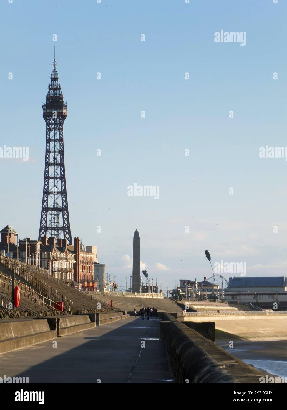 View of blackpool tower from the promenade with town buildings in ...