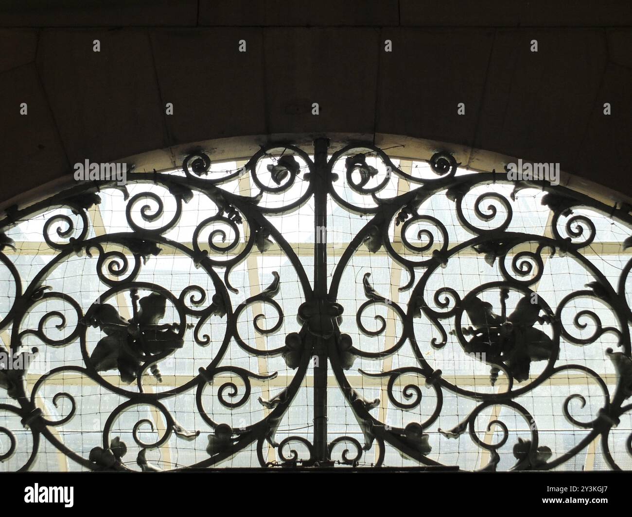 Decorative old spiral wrought iron work above a door Stock Photo - Alamy