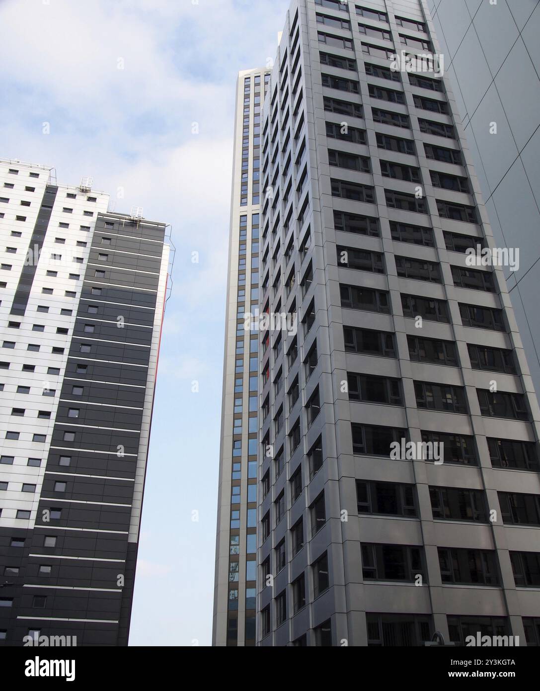 Close up perspective detail of a row of tall high rise modern apartment ...