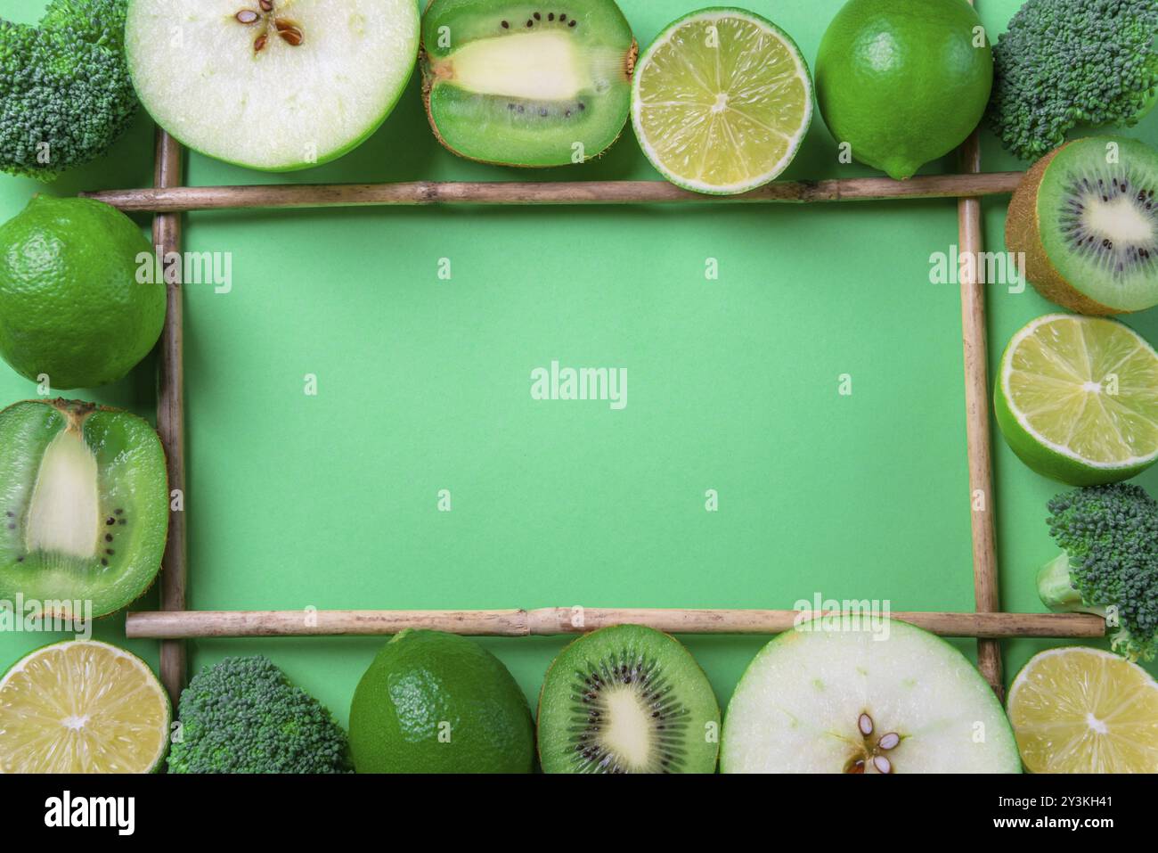 Above view of a frame made from fresh green fruits and broccoli, on a ...