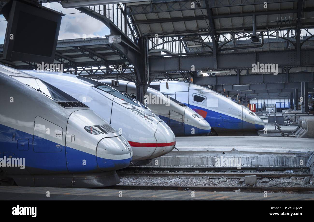 Four different types of high-speed modern trains, stationed in the ...