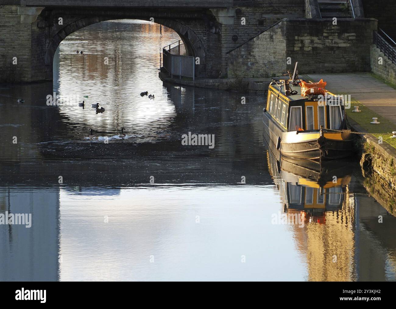 An old traditional narrow boat moored on the canal near brighouse basin ...