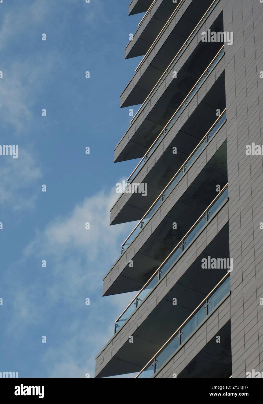 Angled balconies with glass covered railings on a modern apartment ...