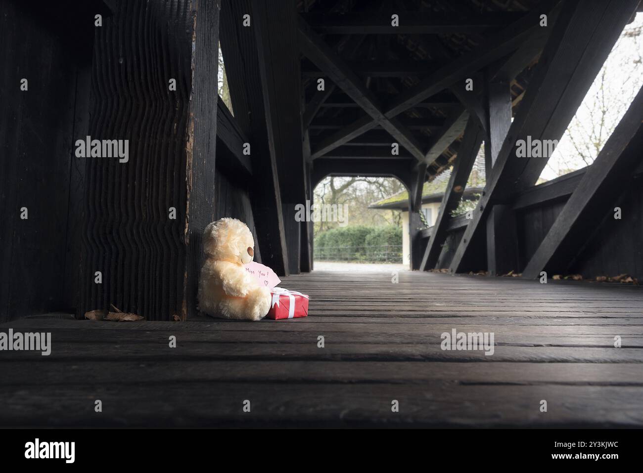 Gifting theme image with a stuffed bear toy holding a red gift box and ...