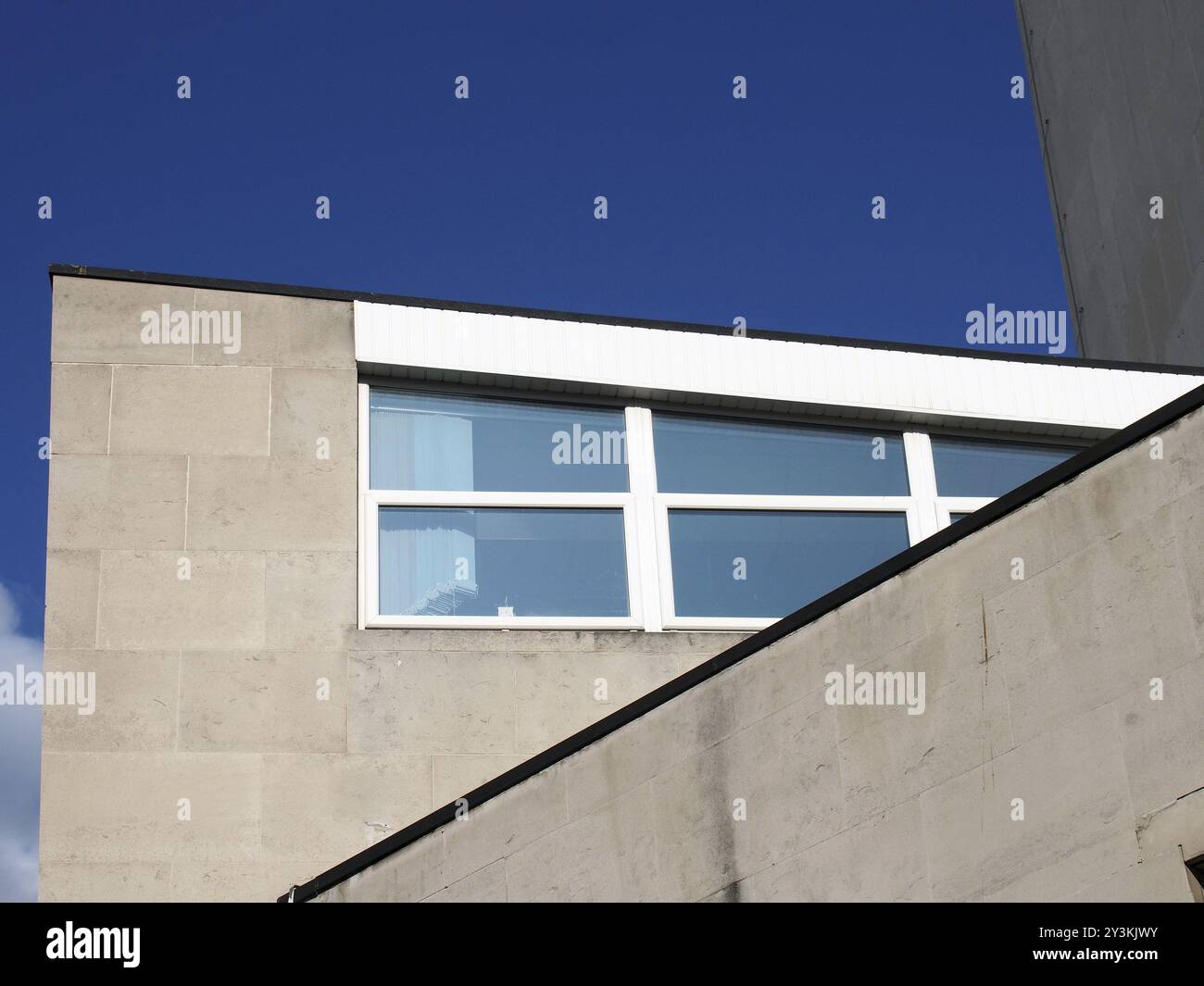 Angular close up view of an old 1960s concrete brutalist stye building ...
