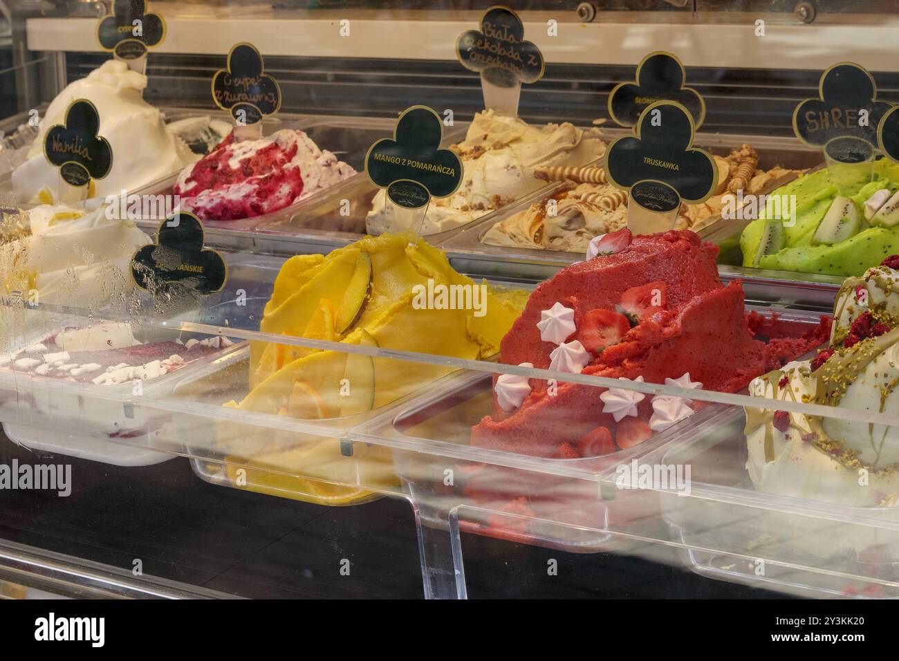 cream on a table colorful in an ice cream display case behind glass ...