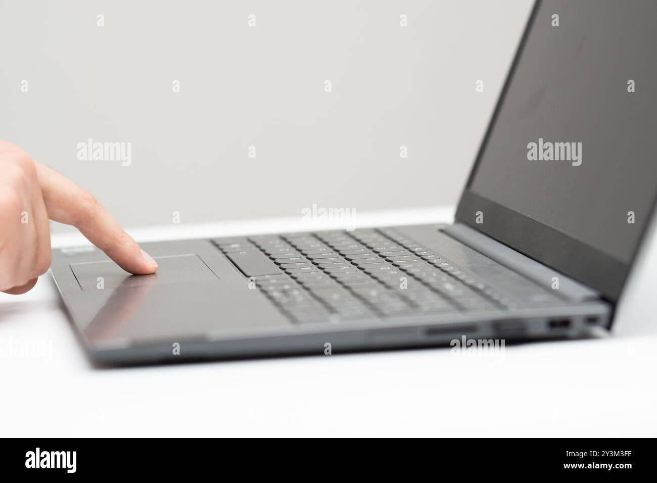 Male finger touching laptop touchpad Stock Photo - Alamy
