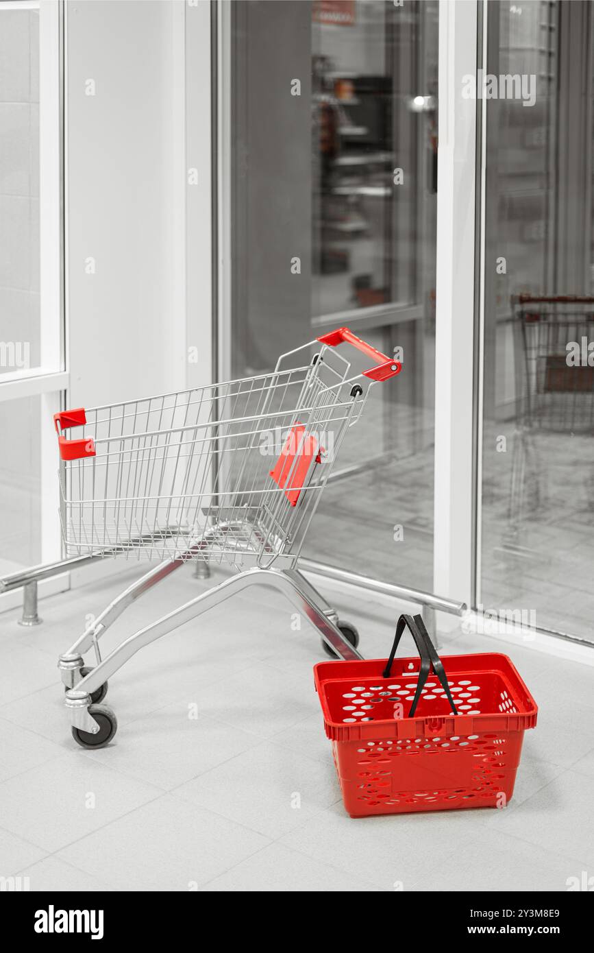 shopping cart and basket in supermarket entrance Stock Photo - Alamy