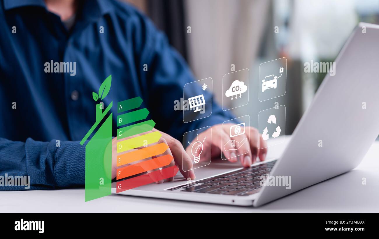 Energy efficiency icons on laptop screen, green smart home hologram in ...