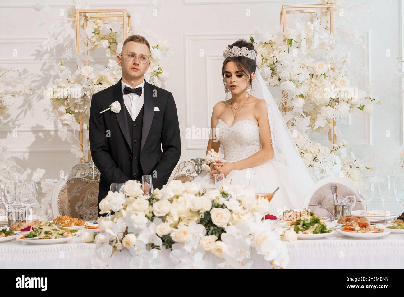 Elegant Wedding Couple Posing at a Luxurious Reception Table Adorned ...