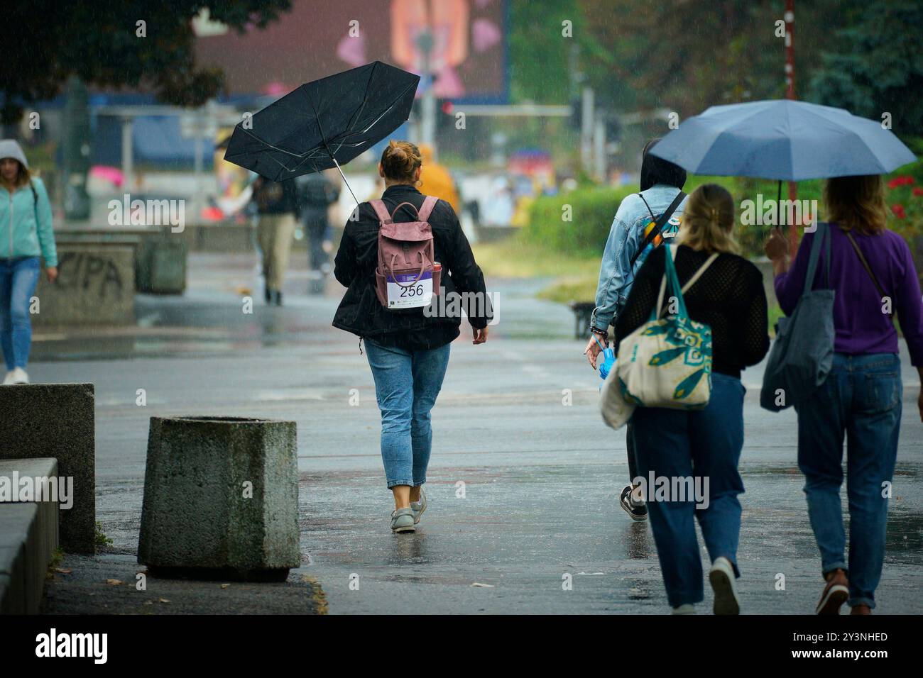 People with umbrellas are seen during a bout of rain in Warsaw, Poland ...
