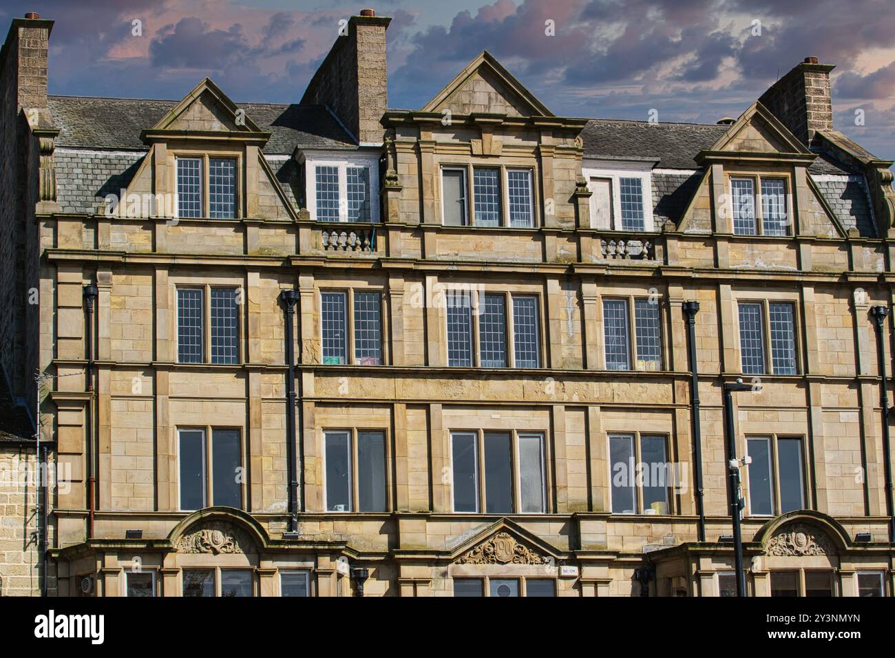 A close-up view of a historic stone building facade featuring multiple ...