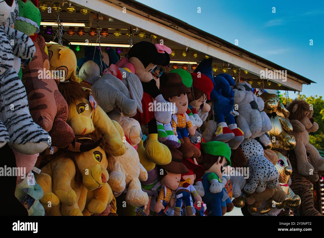A vibrant display of stuffed animals and plush toys hanging from a ...