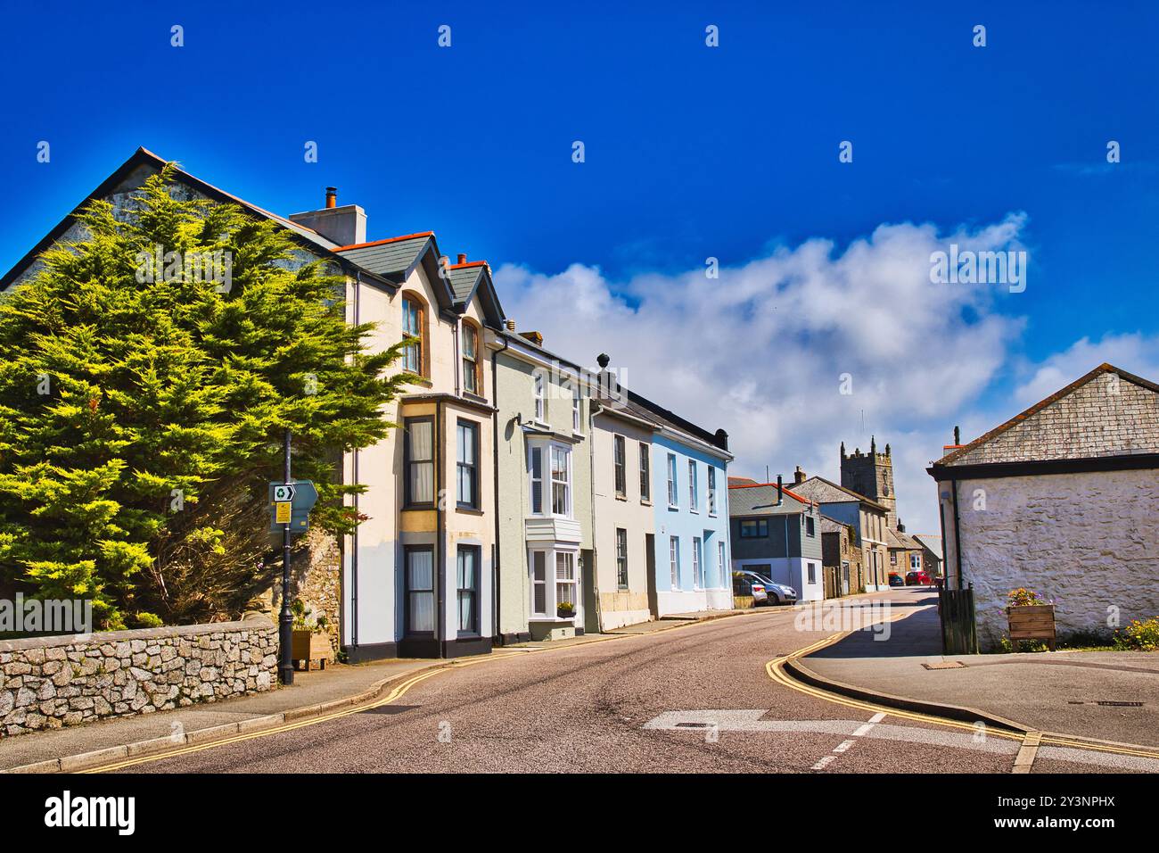 A picturesque street scene featuring charming houses with colorful ...