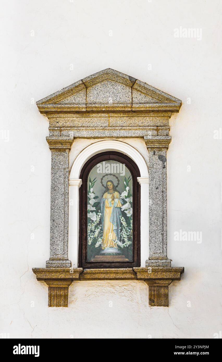 The Virgin Mary standing in a niche of a street of Castuera Stock Photo ...