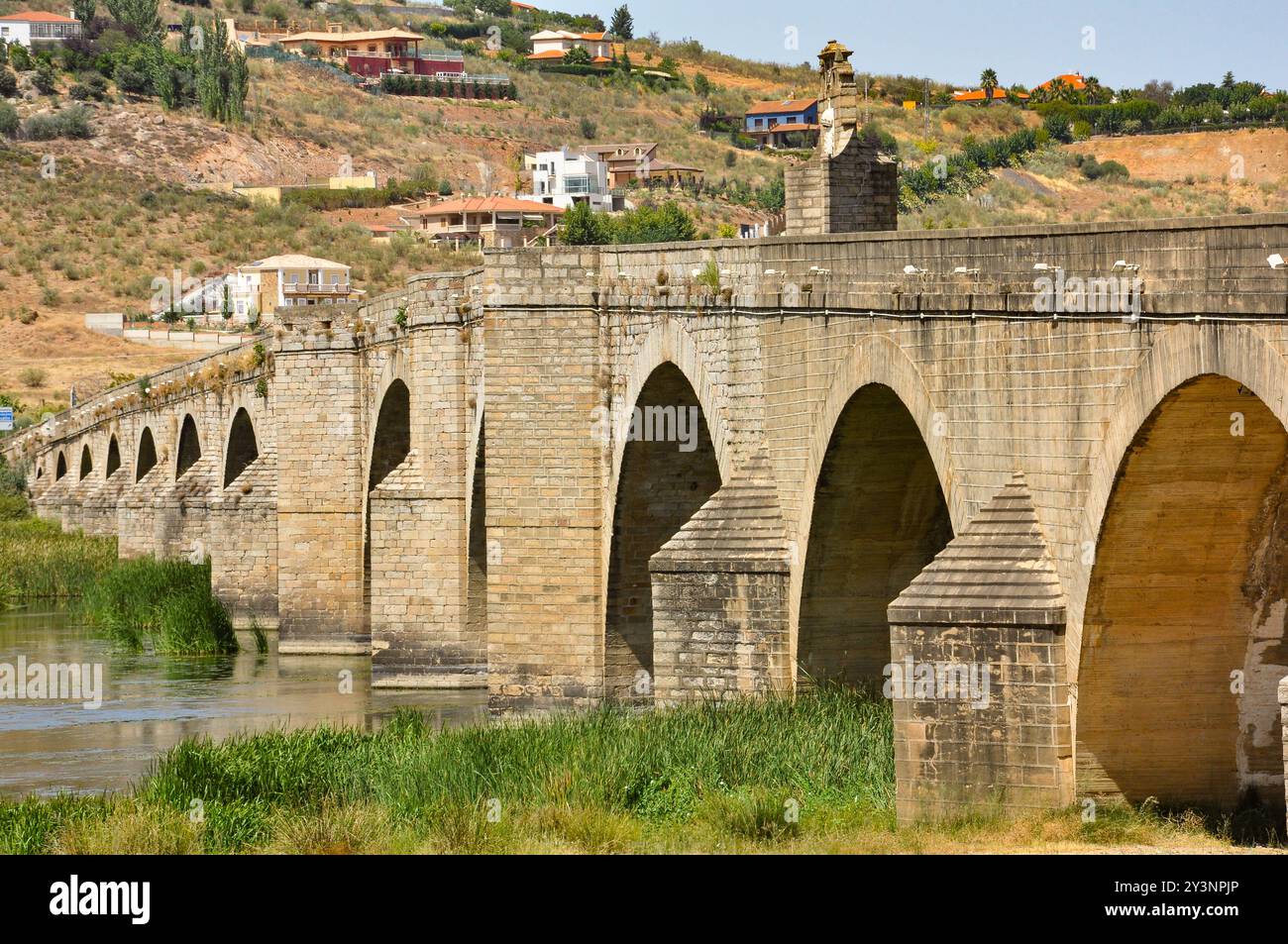 17th century stone bridge over the Guadiana River in the small Spanish ...