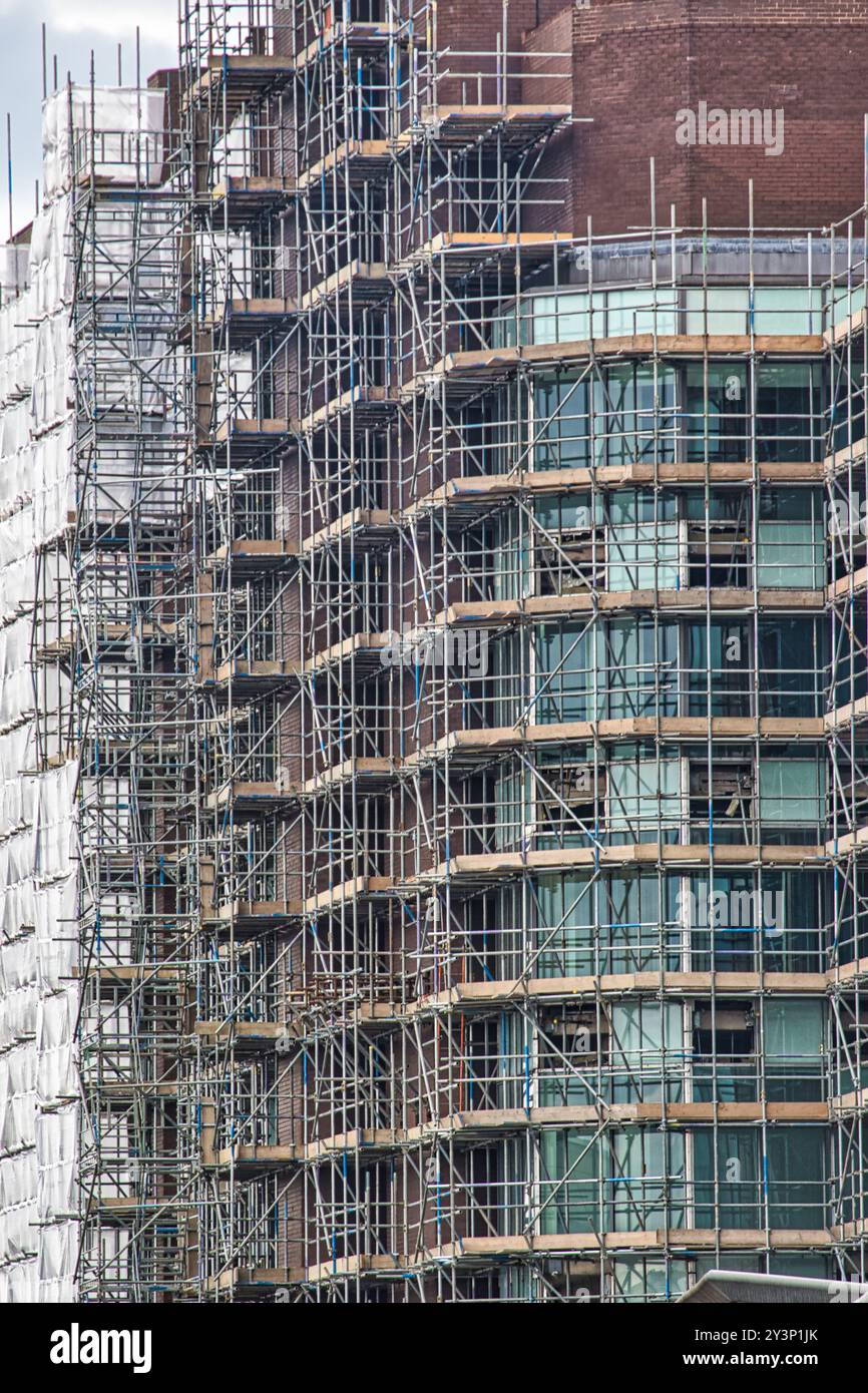 A close-up view of a building under construction, featuring scaffolding ...