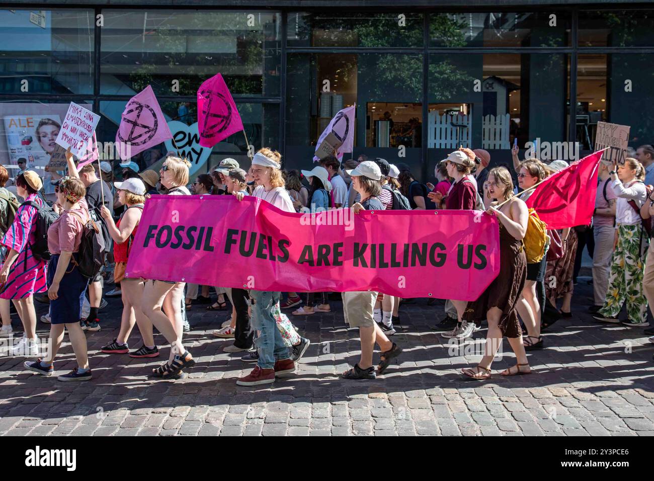 Fossil Fuels are Killing Us. Protesters marching with a pink banner at ...