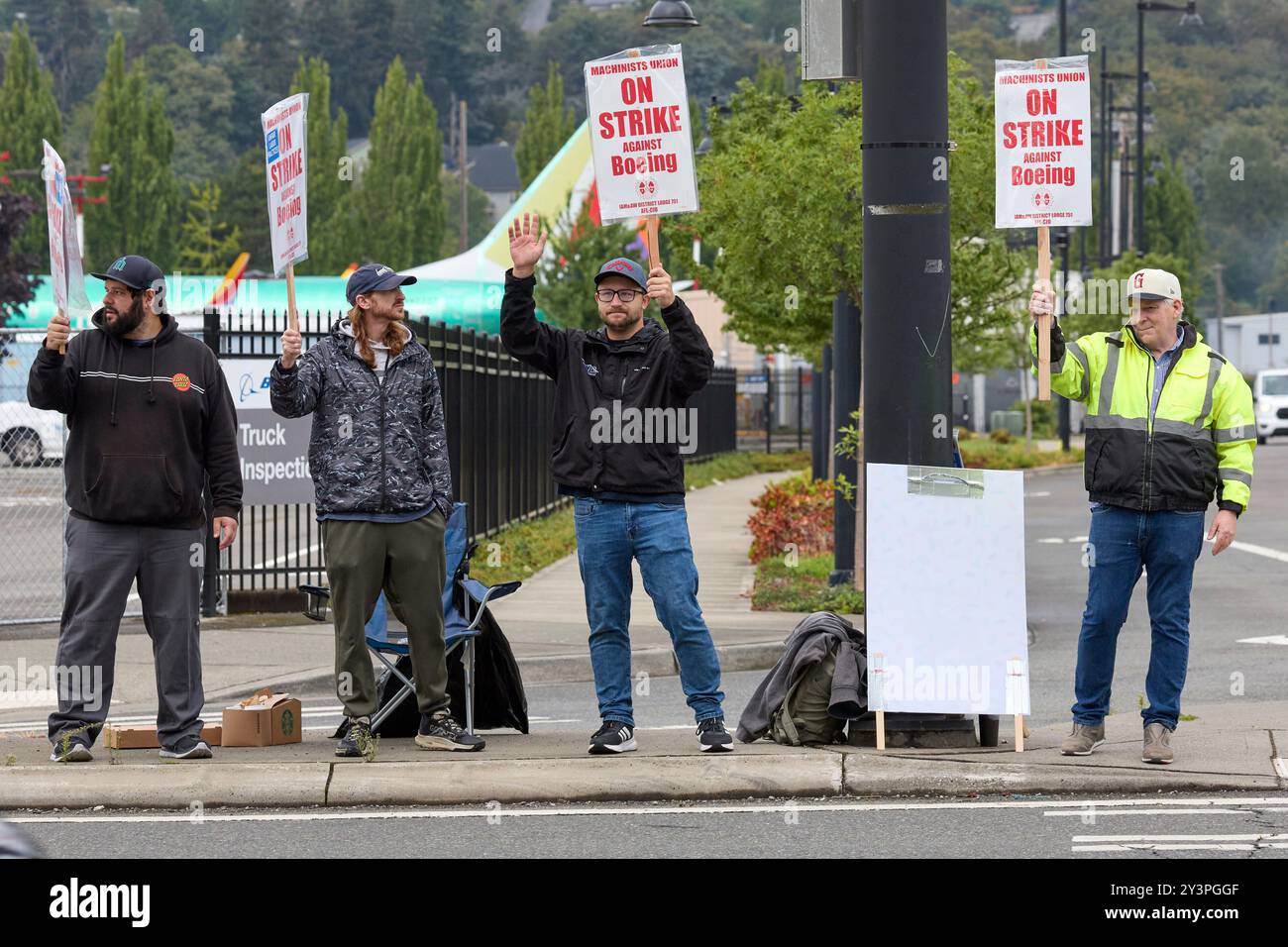 Boeing Machinists Union members, with completed airplanes visible ...