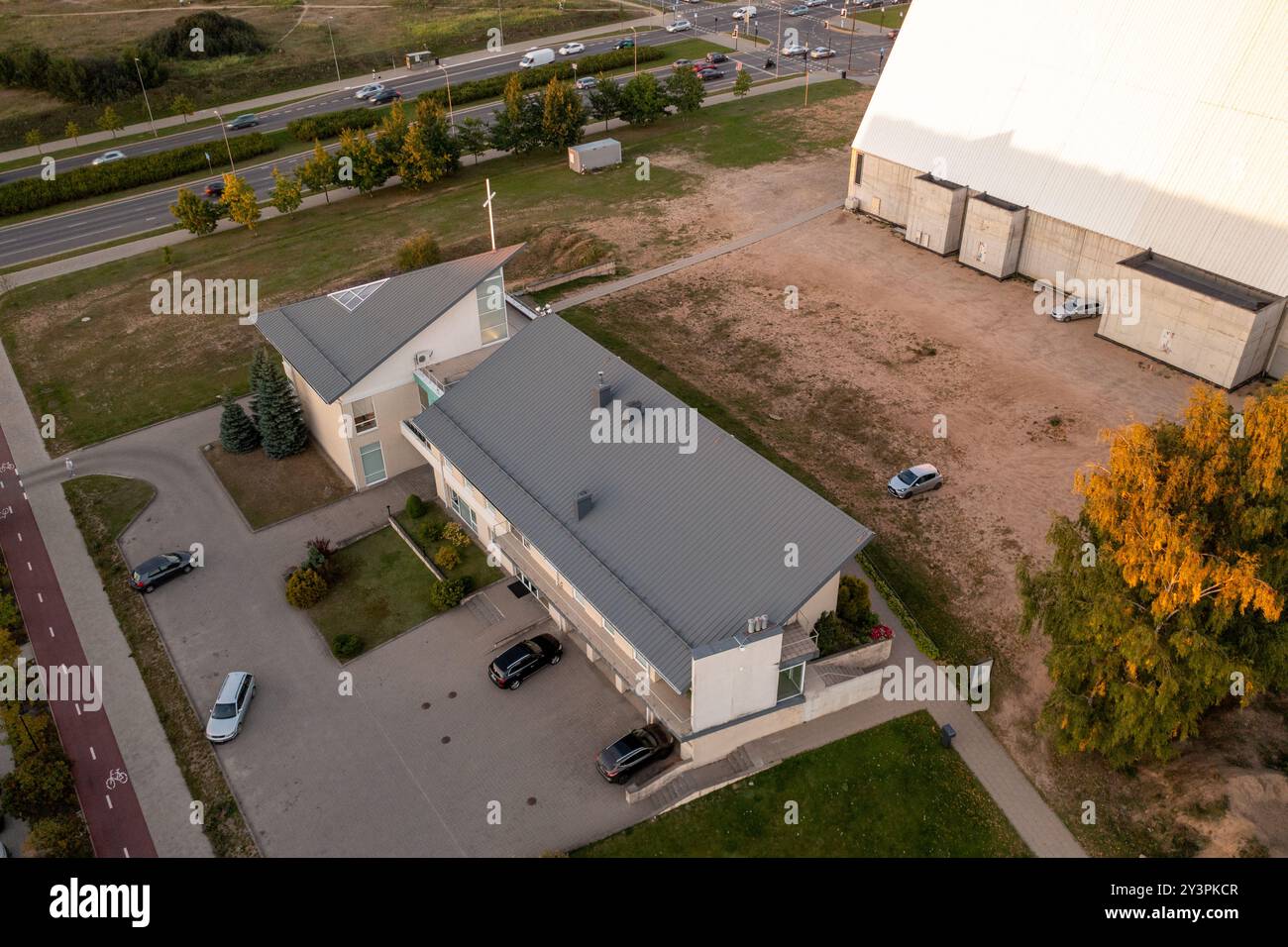 Aerial view of a modern church with a triangular roof in an urban area ...