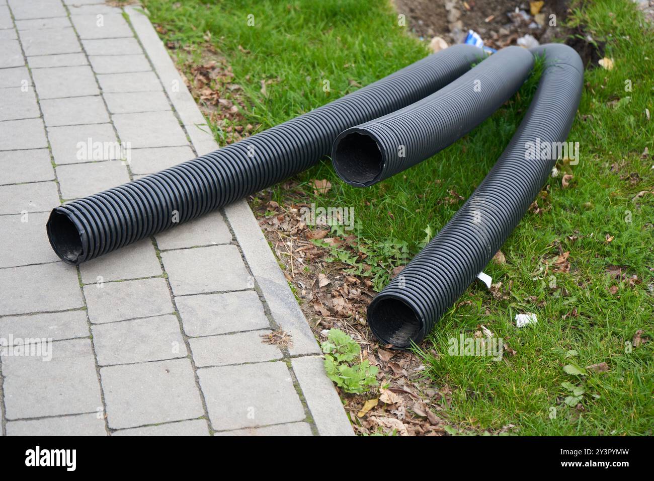 laying the pipe next to the pavement Stock Photo - Alamy