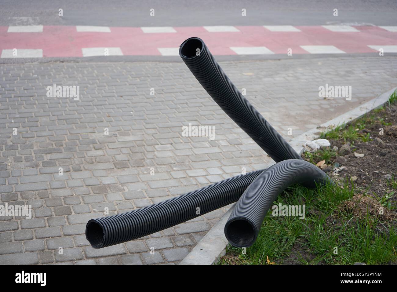 corrugated pipes are buried near the road, sewer pipes protrude from ...