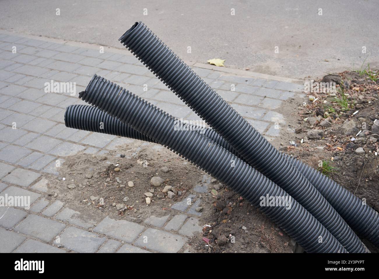 industrial corrugated pipes buried in the ground, three pipes protrude ...