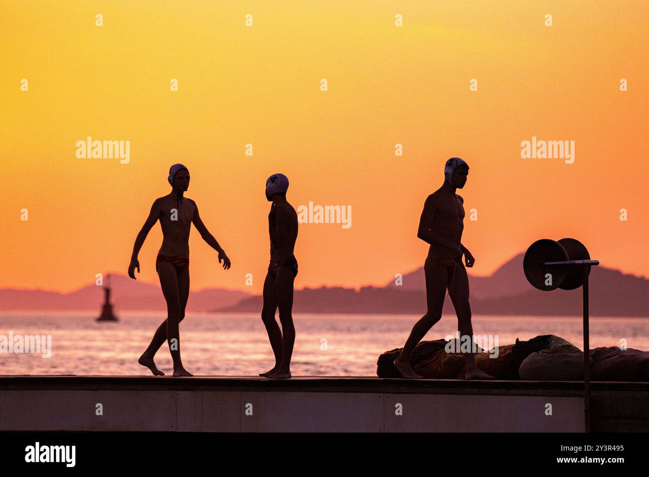 Three muscular men enjoy the sunset in Cavtat, Croatia Stock Photo - Alamy