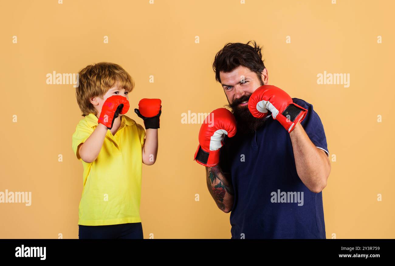 Child boy sportsman at boxing training with coach. Kid and trainer in ...