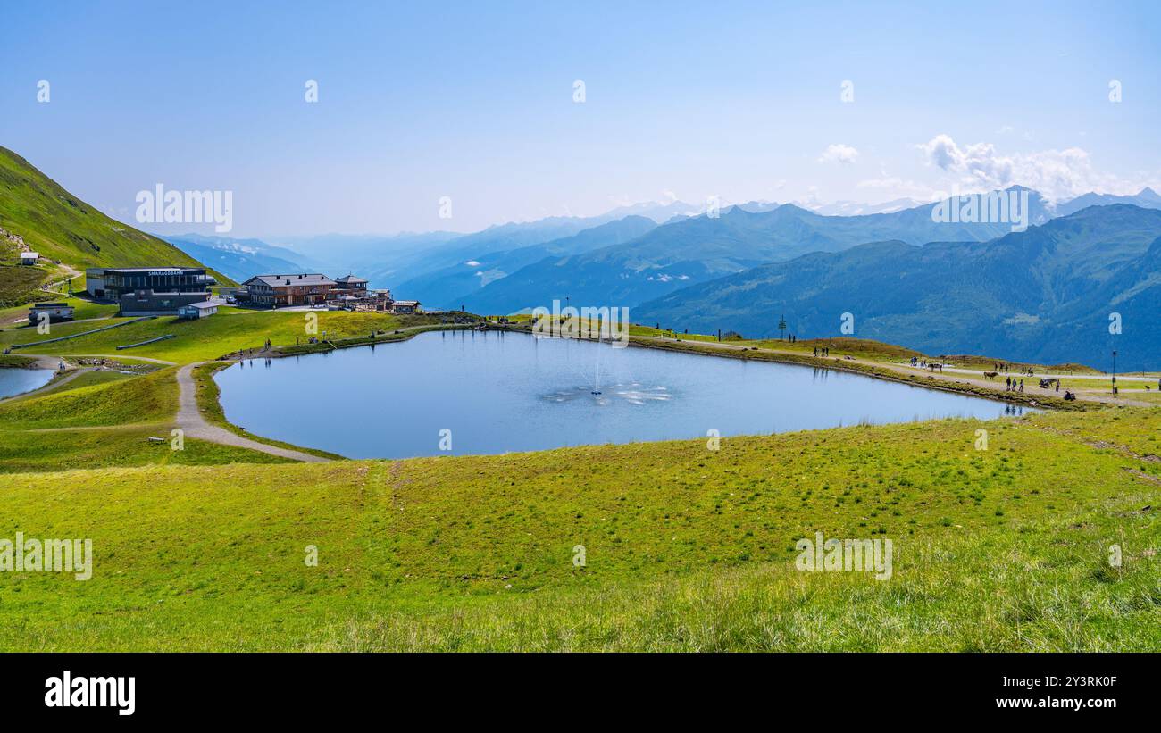 This picturesque view features the Wildkogel water reservoir surrounded ...